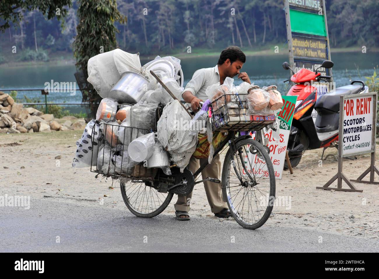 A transport bike loaded with large loads on a road, Pokhara Valley ...