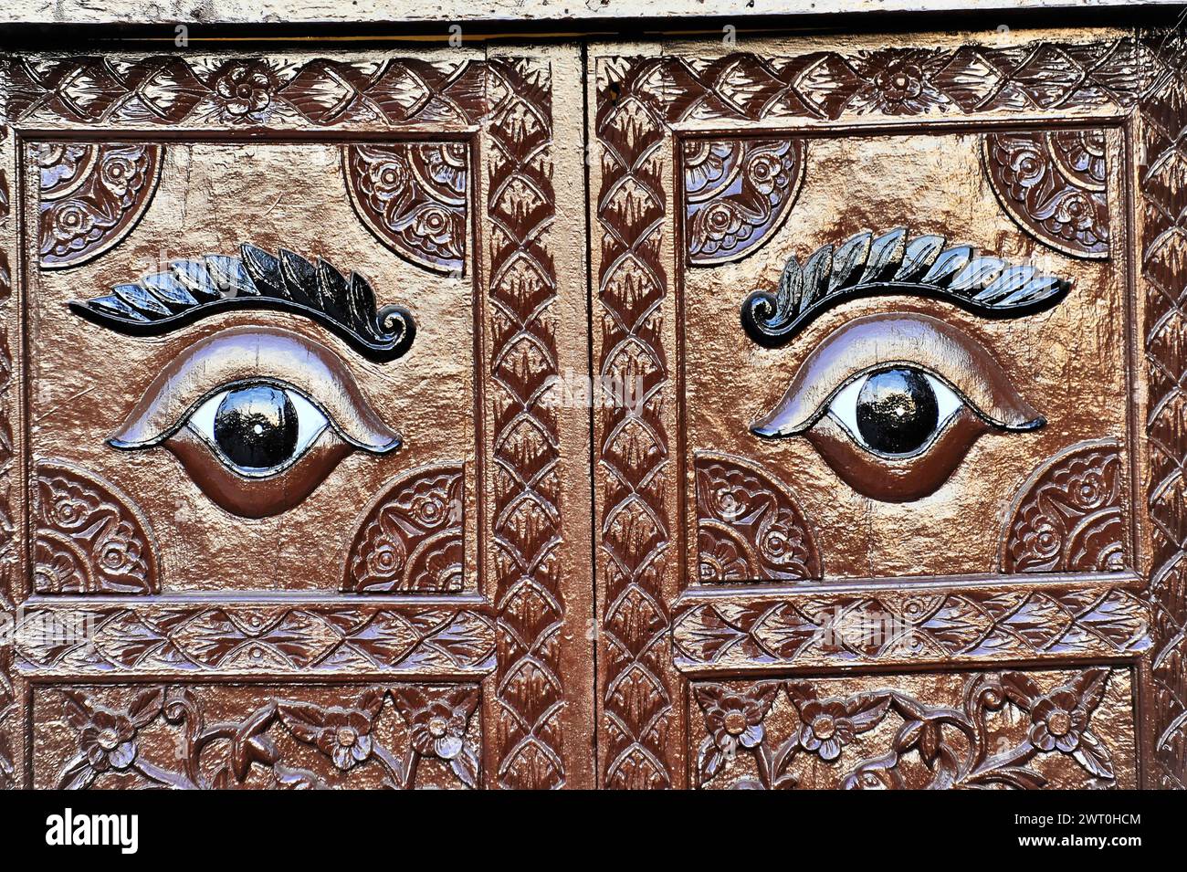 Two artistically carved eyes as wall decoration with detailed texture ...
