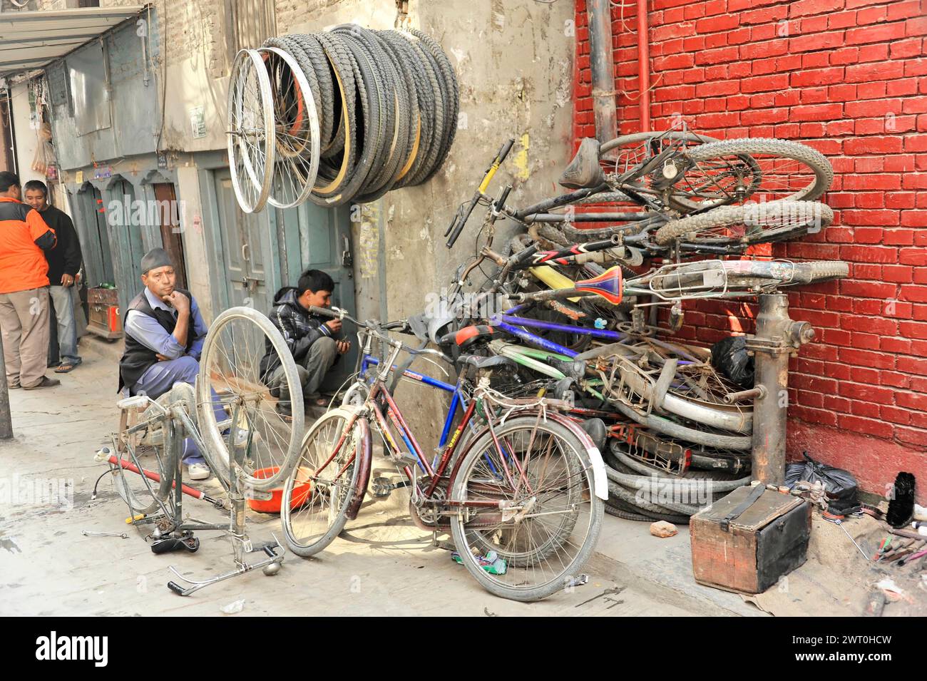 Bicycle shop with stacked bikes and a worker on the street, Kathmandu ...