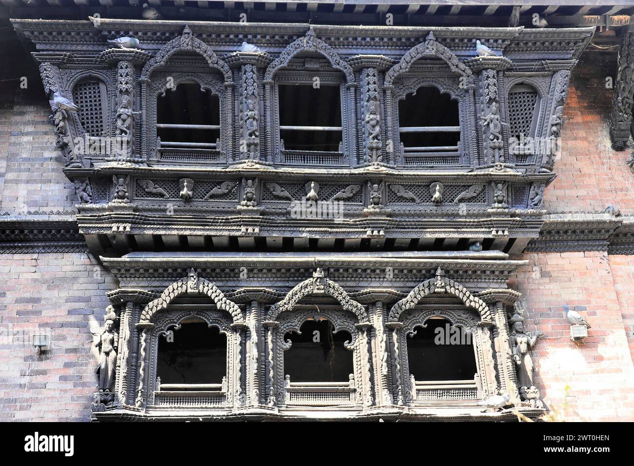 Detailed wood carvings on the windows of a historic building, Kathmandu ...