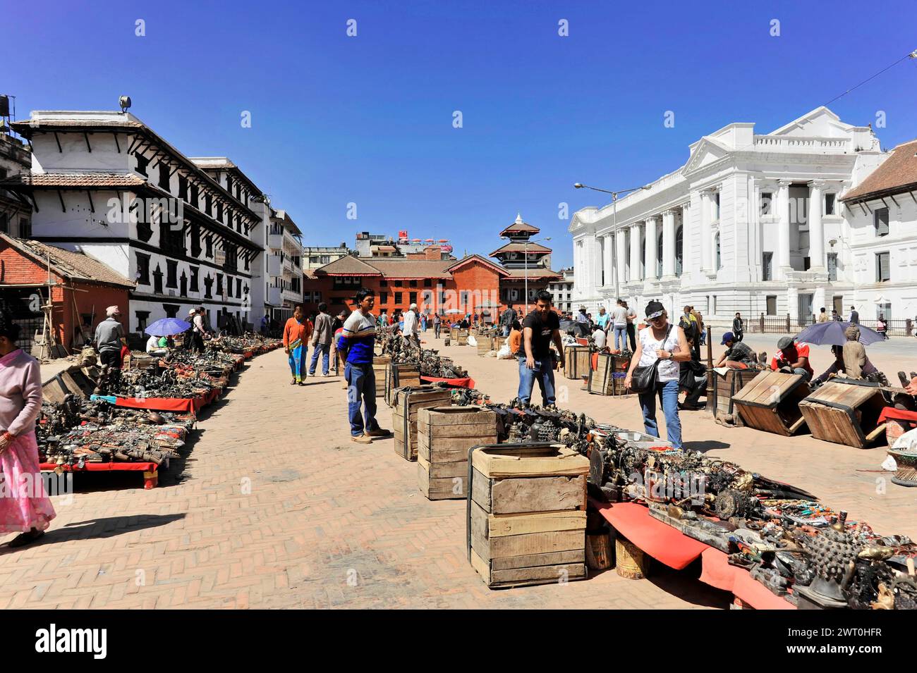 Lively market in front of historic architecture under a blue sky ...