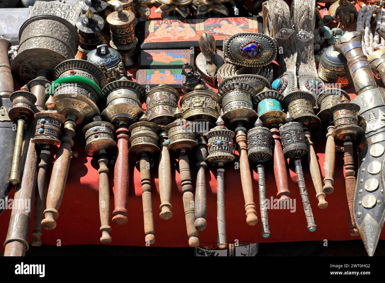Traditional prayer wheels on a market stall with detailed metal ...