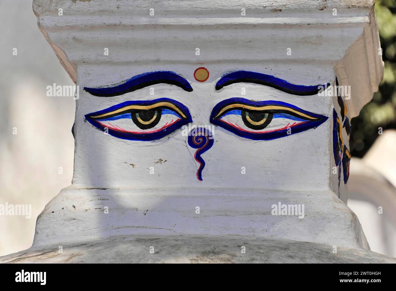 Painted Buddha eyes on a blue background at the top of a stupa ...