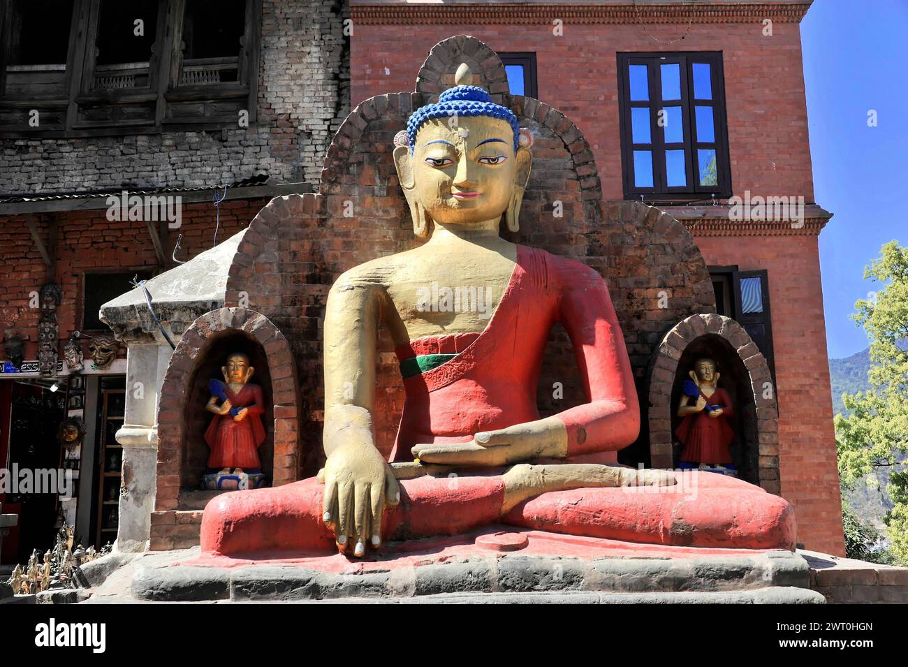 Large Buddha statue in a meditative pose in front of a house, Kathmandu ...