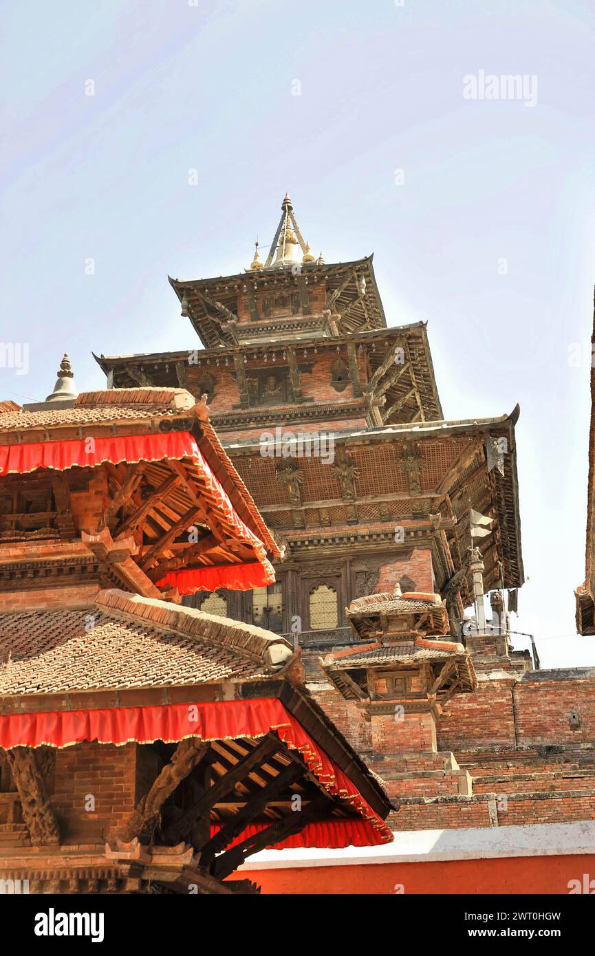 A tall temple tower rising into the blue sky, Kathmandu Valley ...