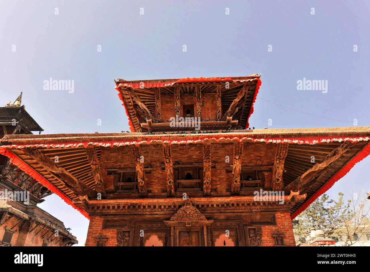 Close-up of a temple roof with fine decorations under a clear sky ...