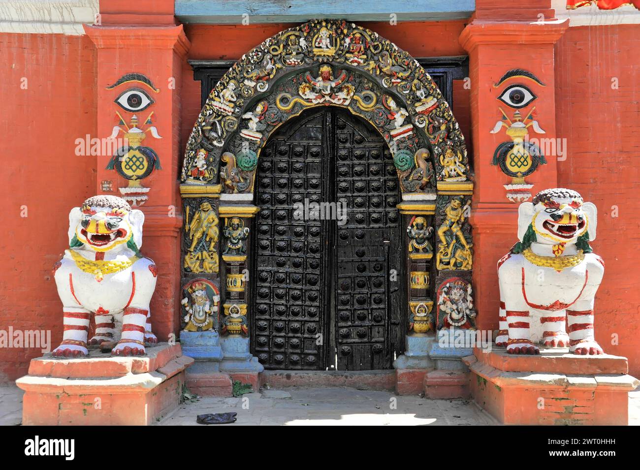 Colourful and richly decorated gate with sculptures and traditional ...