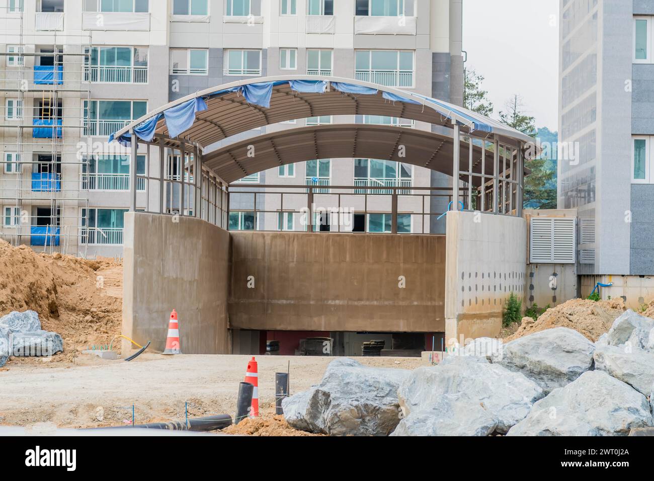 Covered entrance ramp to underground parking at construction site of ...