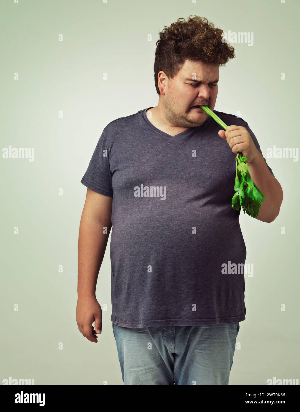 Plus size, diet and disgusted man eating vegetable for health ...