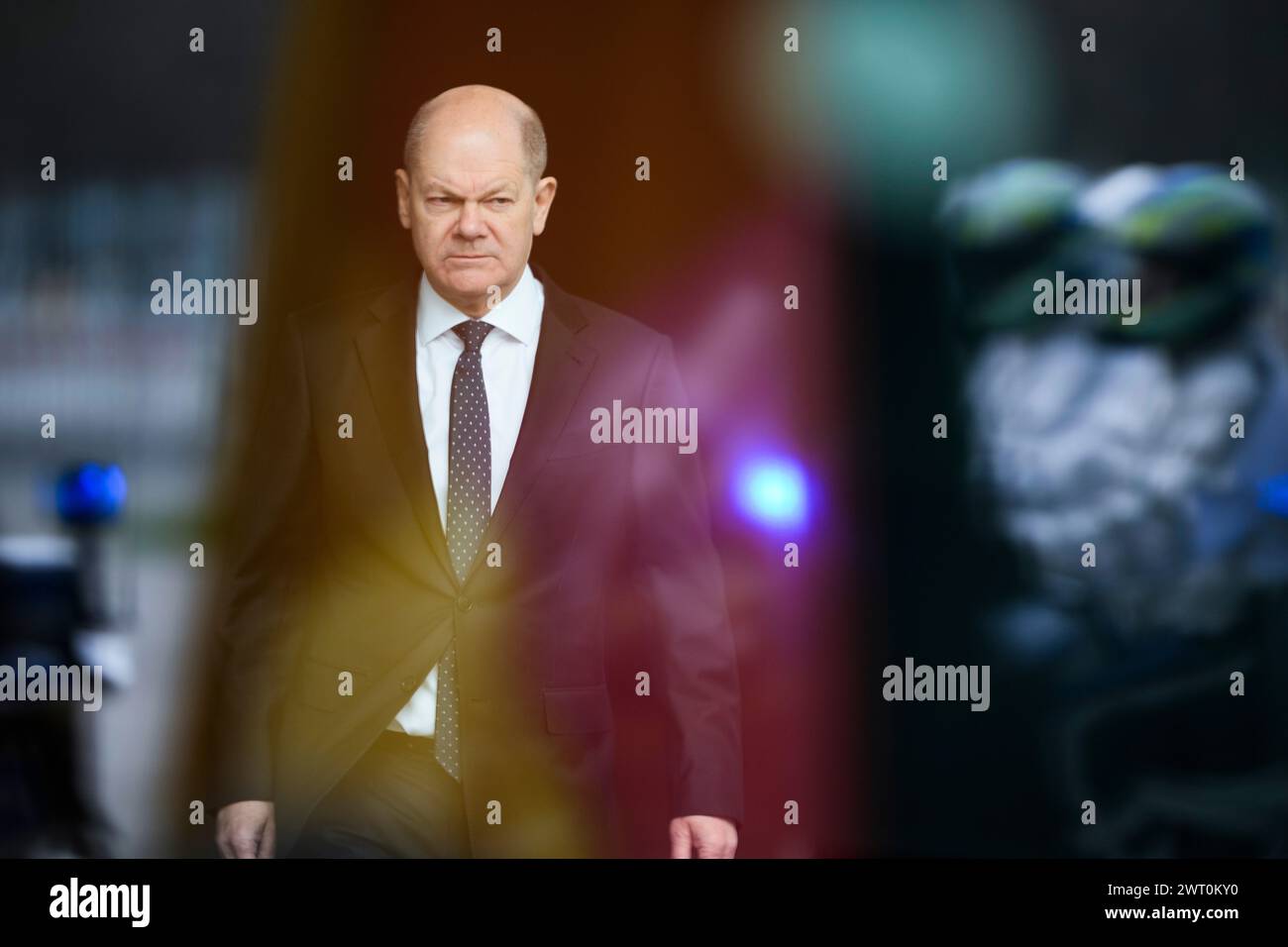 German Chancellor Olaf Scholz walks through the foyer of the ...