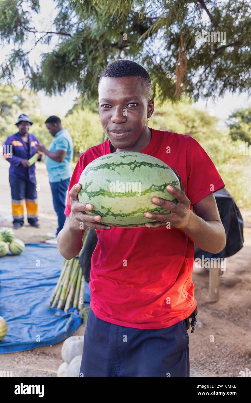 african street vendor selling watermelon on the side of the road ...
