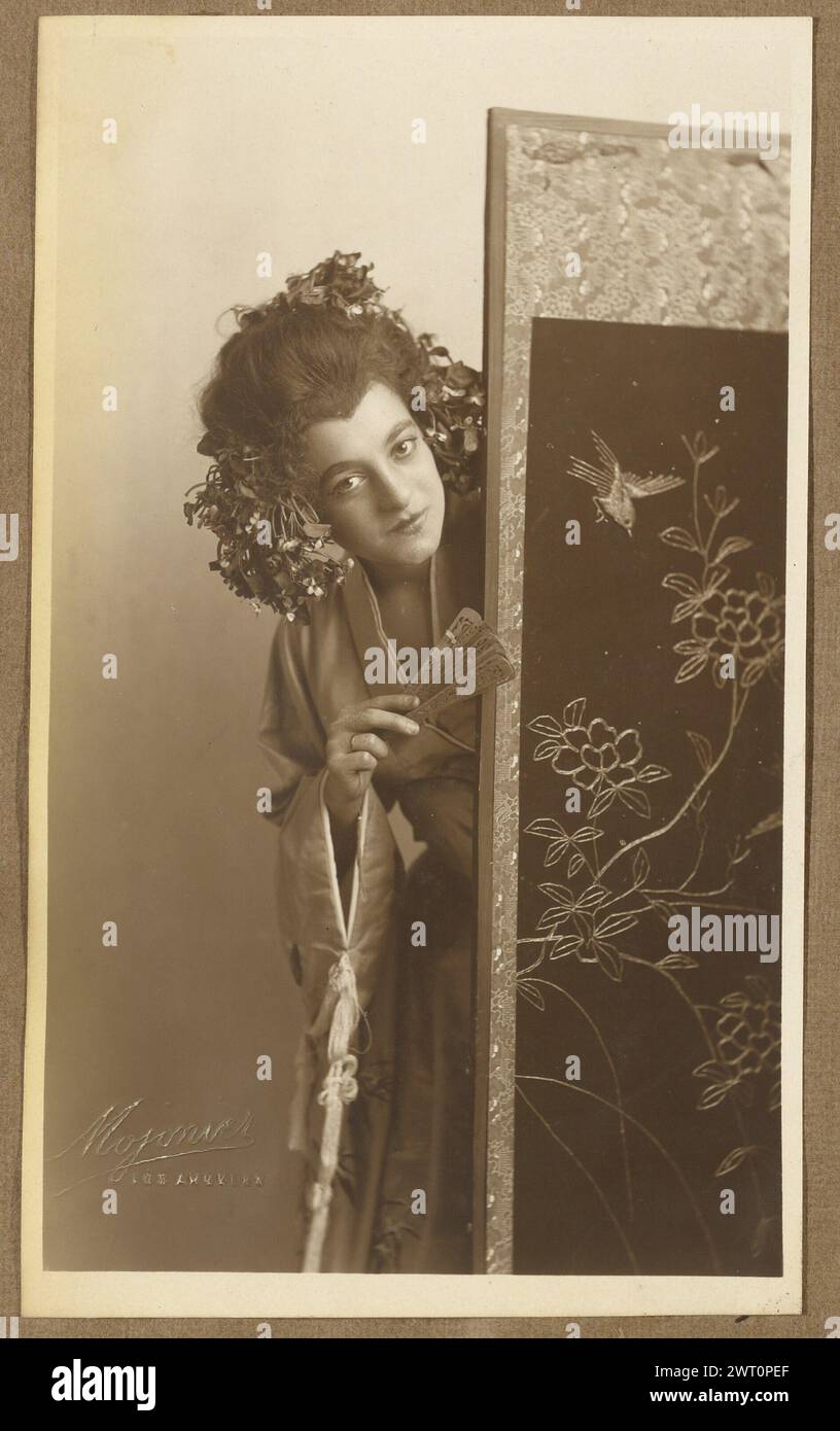 Woman in Oriental costume, looking around Oriental screen. A. Louis ...