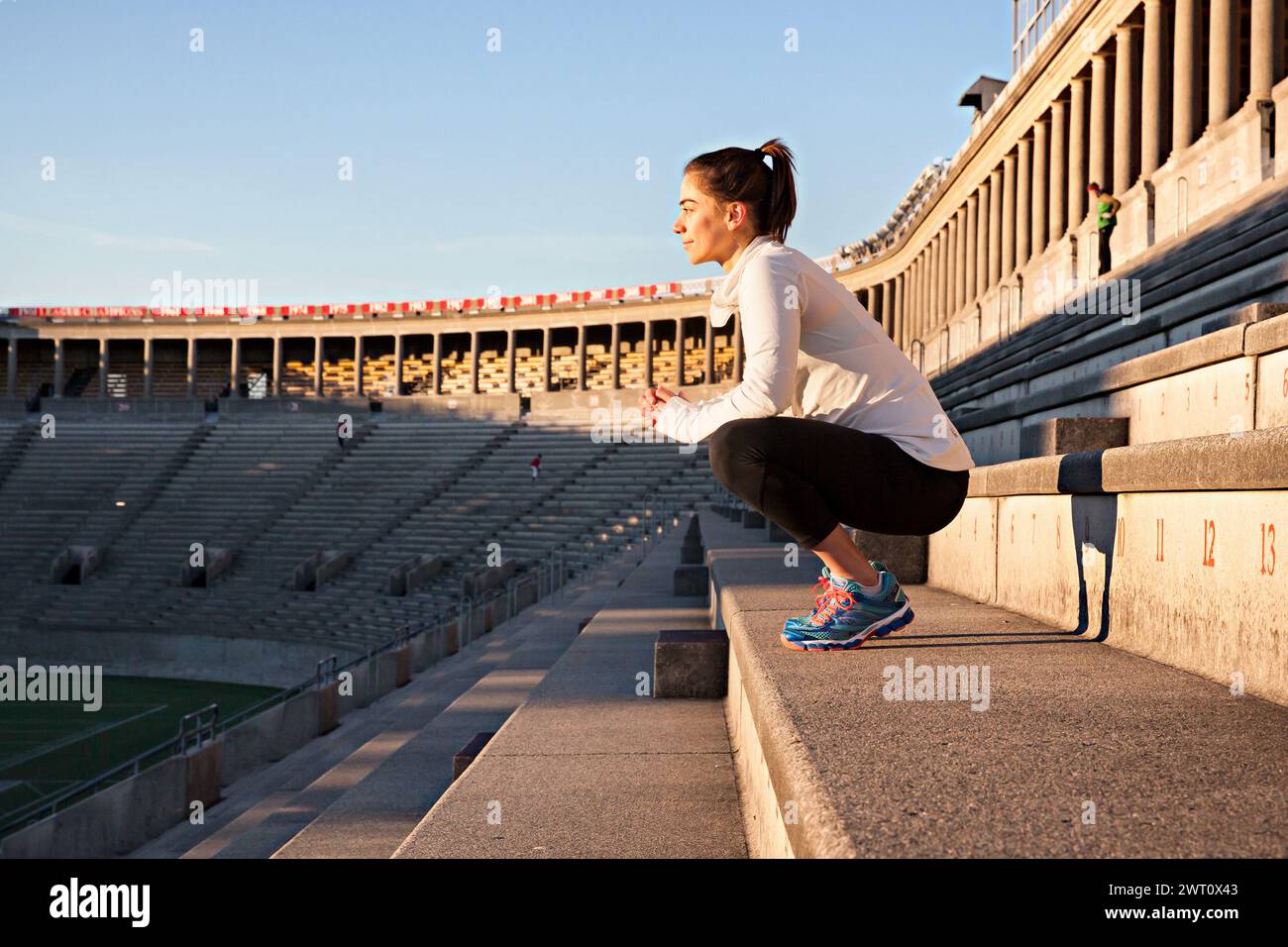 Athletic Woman Overlooking Football Stadium at Dawn Stock Photo - Alamy