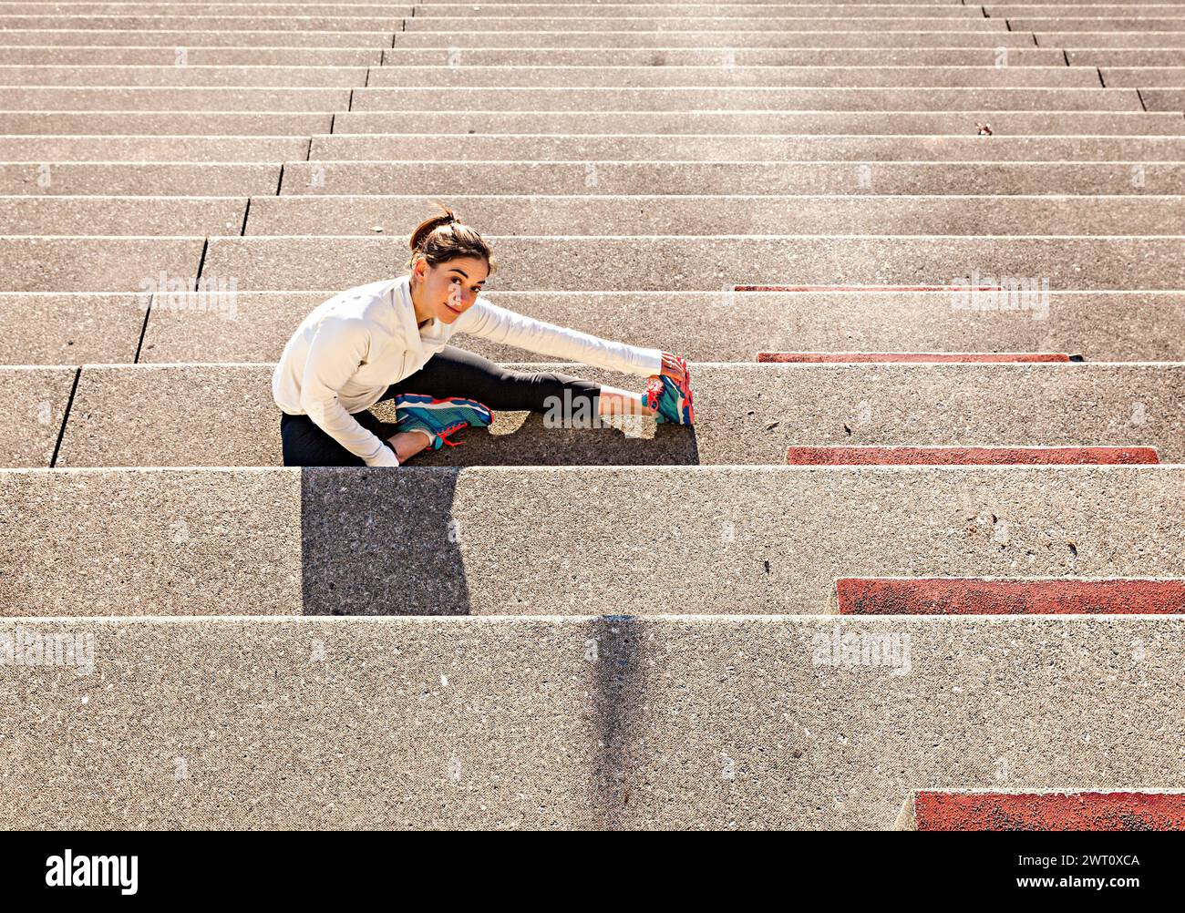 Athletic Woman Stretching on Stairs in Football Stadium at Dawn Stock ...