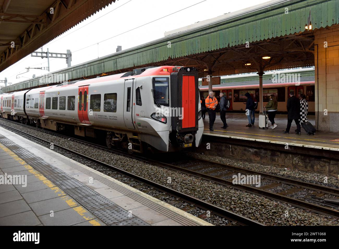 Passengers getting on a new Transport For Wales CAF Class 197 DMU train ...