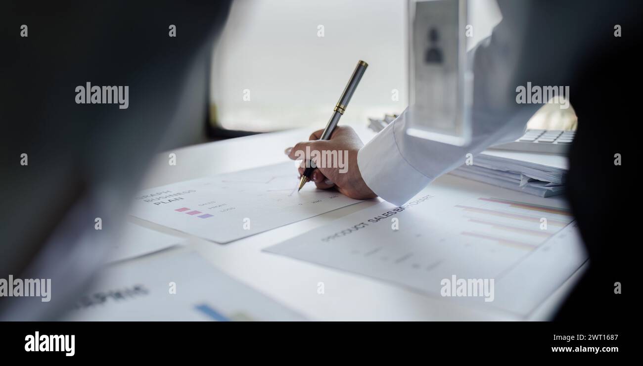 Business people or accountants are analyzing graphs on finance ...