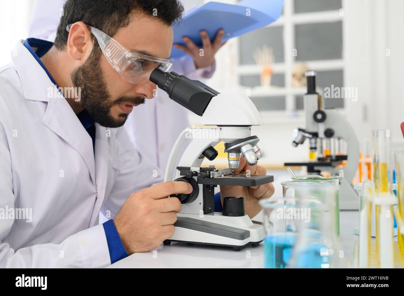 Biotechnology researcher is using a microscope in the lab Stock Photo ...