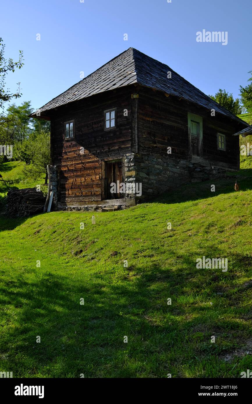 a traditional log cabin with roof of slate in South-Western Serbia ...