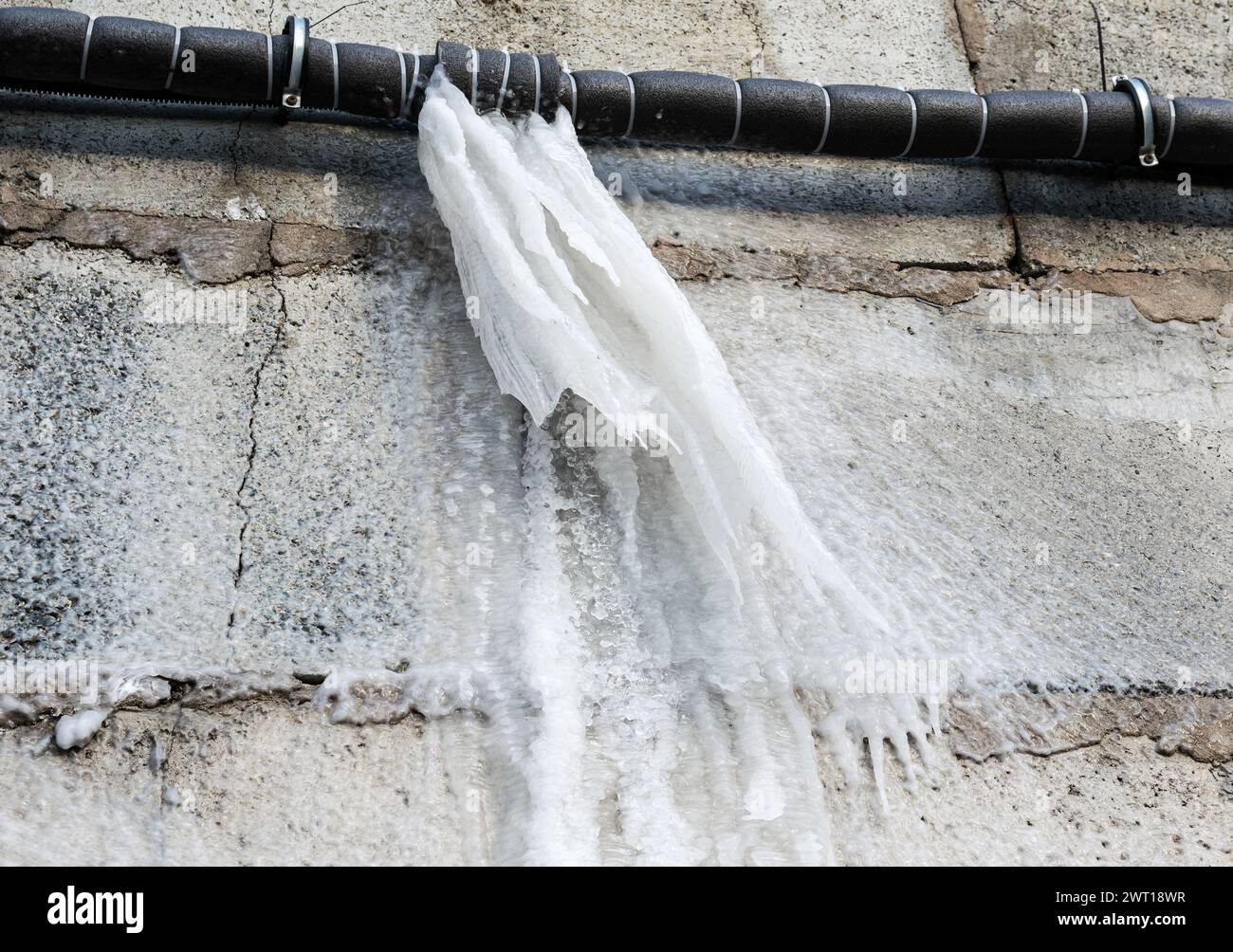 Frozen water after burst from a pipe at the winter Stock Photo - Alamy