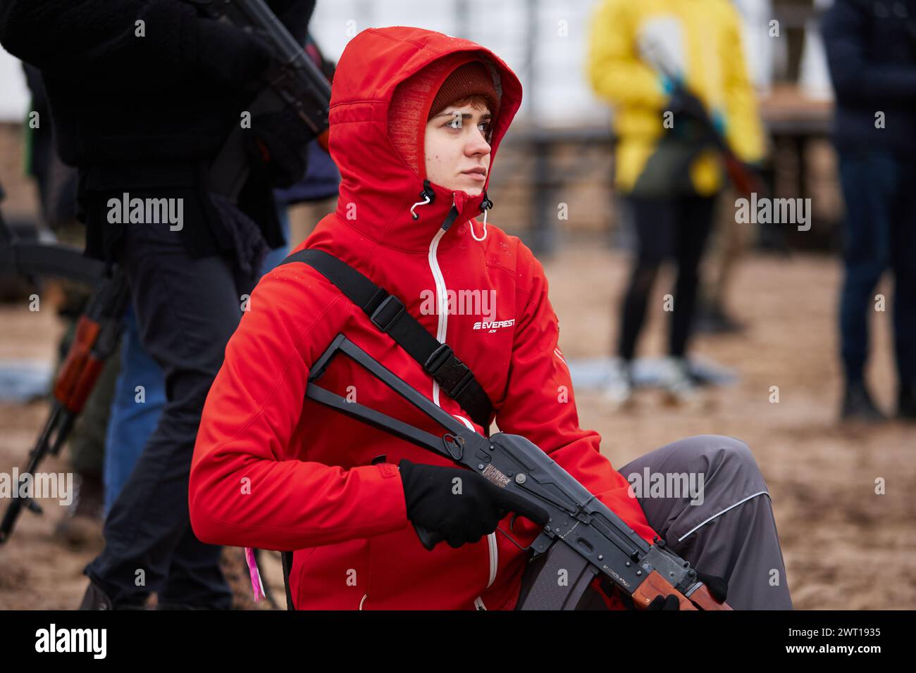 Civil Ukrainian female practicing to handle the AK rifle on a military ...