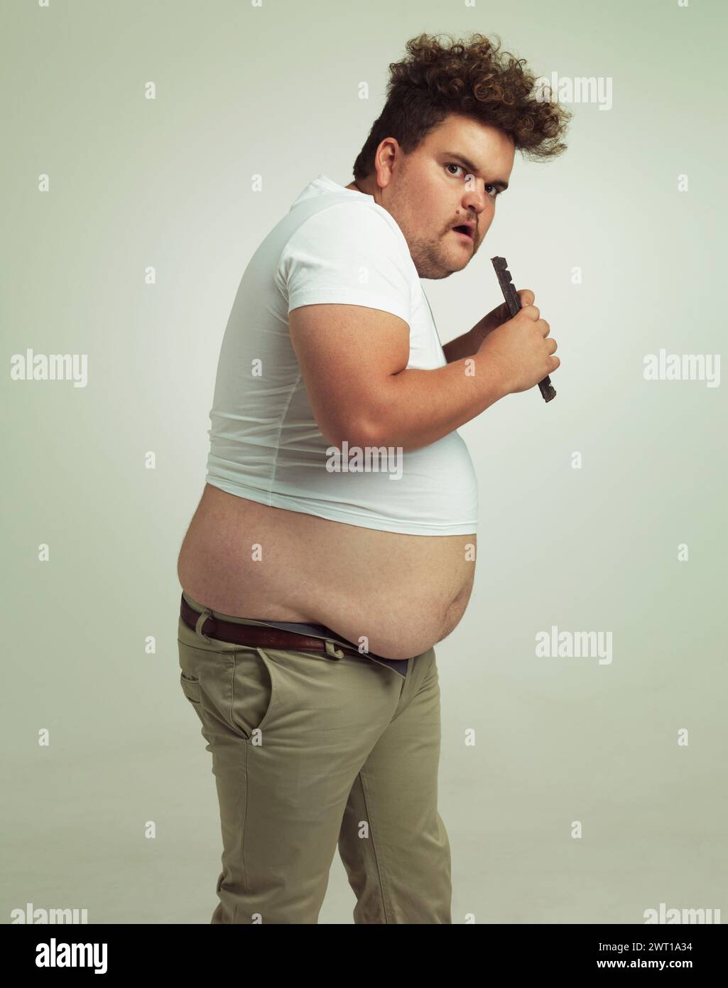 Chocolate, portrait and plus size man with eating food, dessert and ...