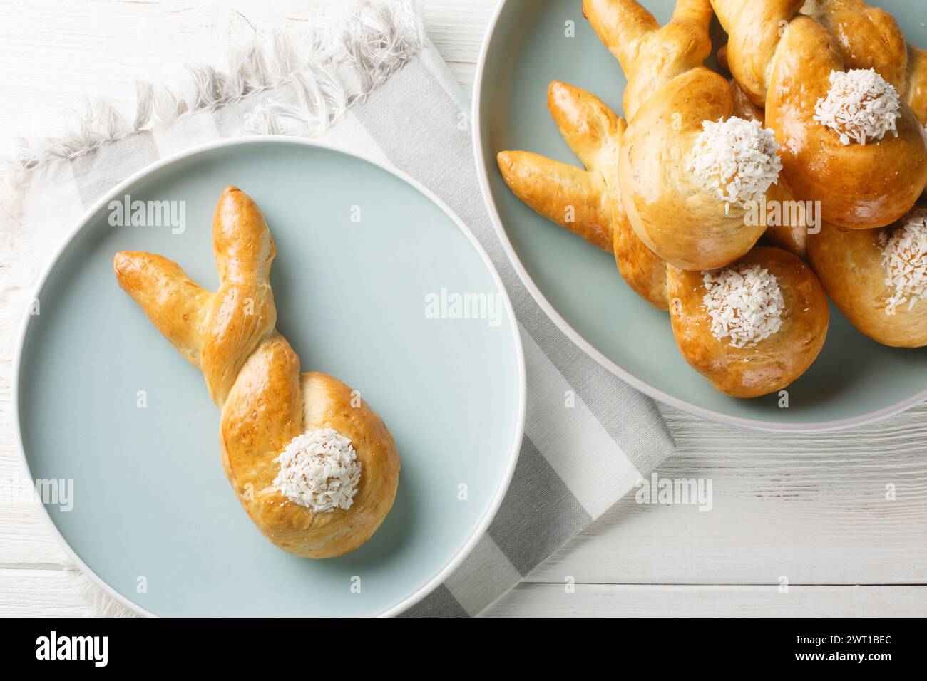 Funny sweet bunnies buns with coconut closeup on a white wooden ...