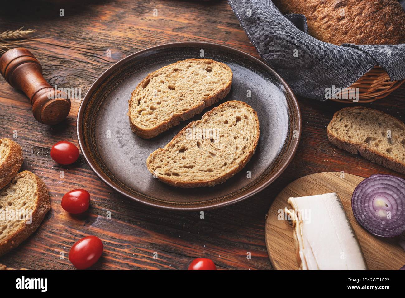 Slices of rustic sourdough bread on rustic background Stock Photo - Alamy