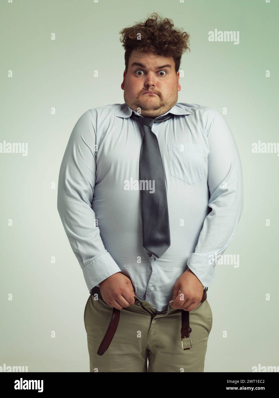 Man, portrait and shocked with plus size pants or big waist in obesity ...