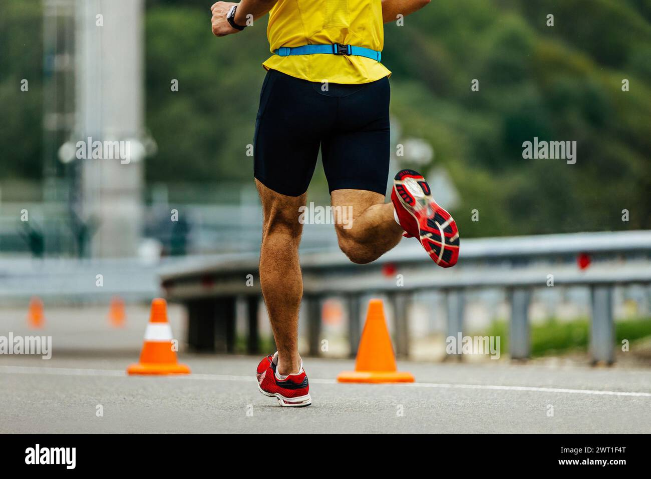 close up man legs running down road with orange safety cones Stock ...