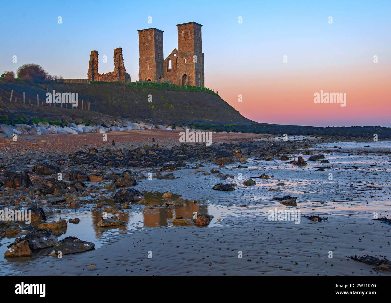 Reculver Towers Kent reflected in shore pools at Dawn on a March Day ...