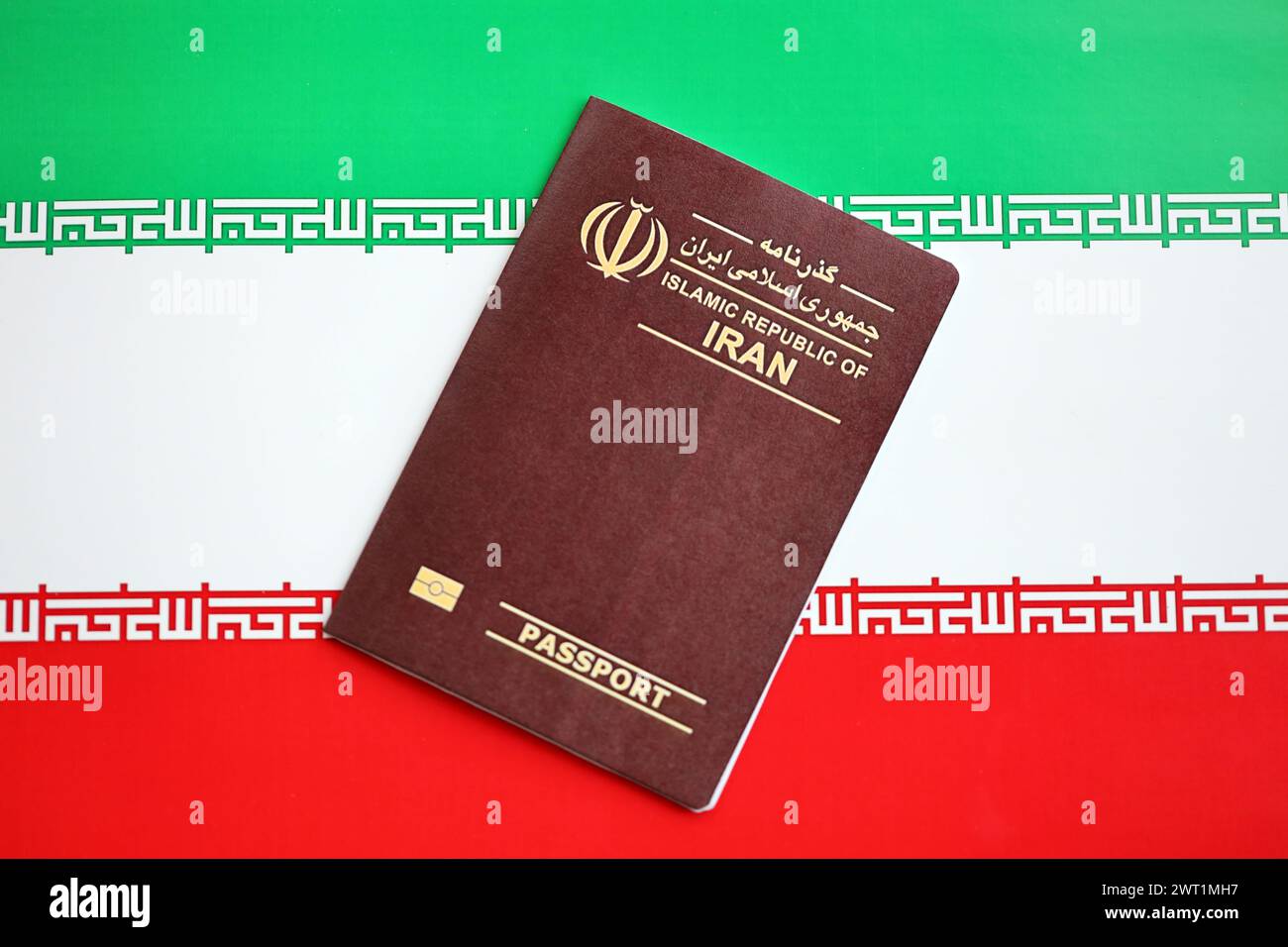 Red Islamic Republic of Iran passport on national flag background close ...