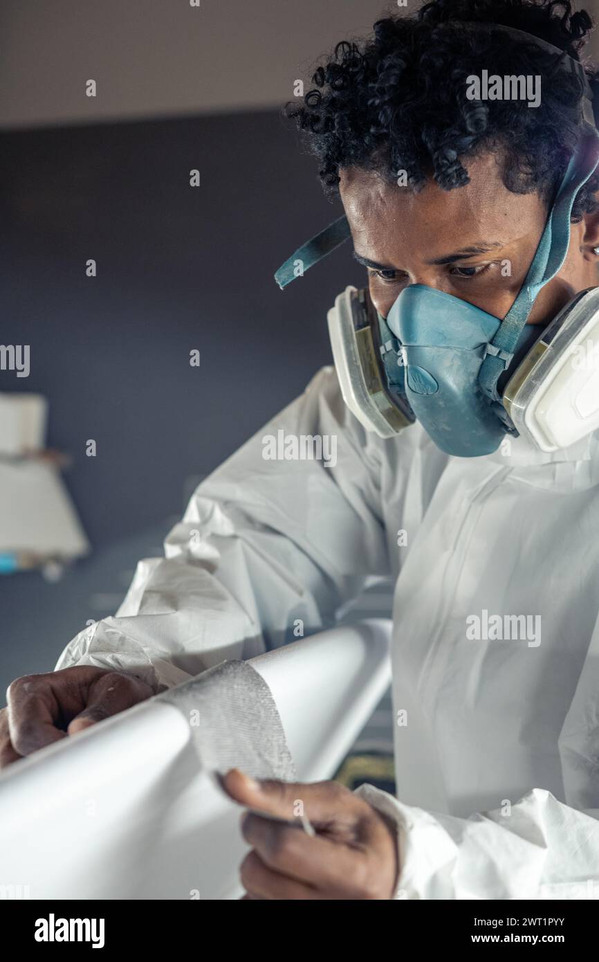 Surfboard manufacturing, Shaper working on board details. Concept of ...