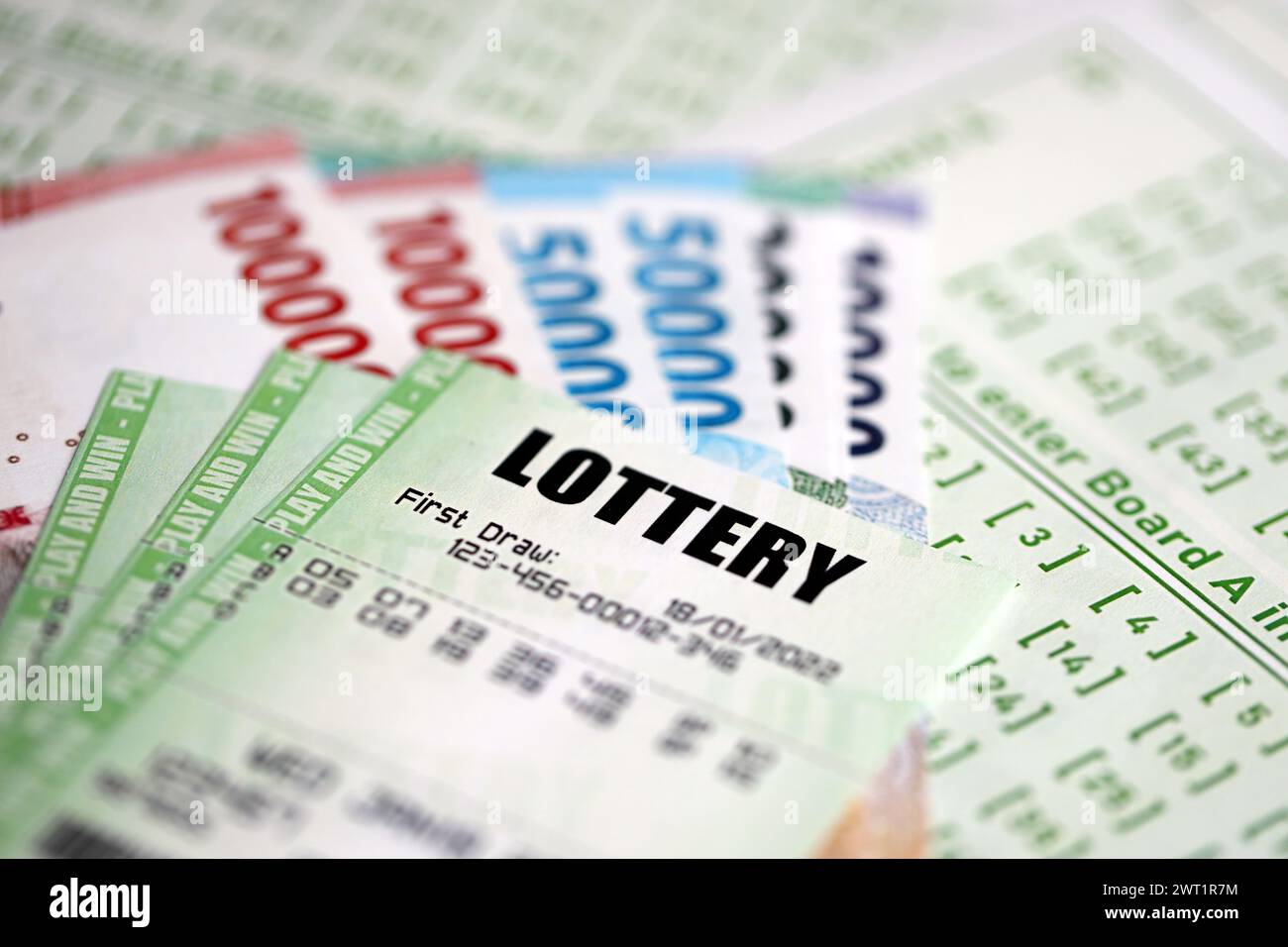 Green lottery tickets and indonesian money bills on blank with numbers ...