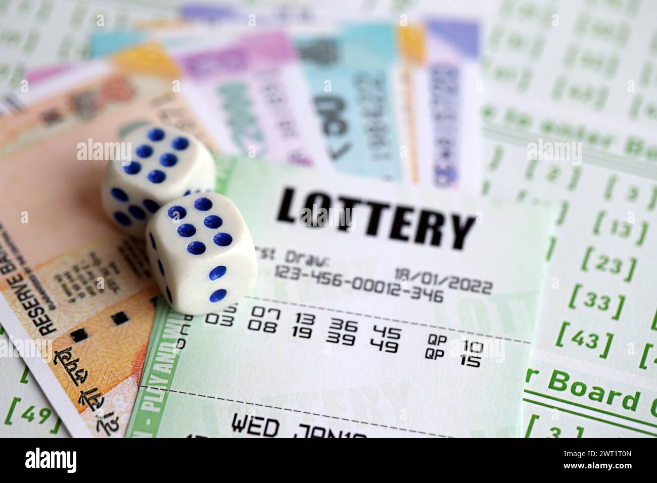 Green lottery tickets and indian rupees money bills on blank with ...