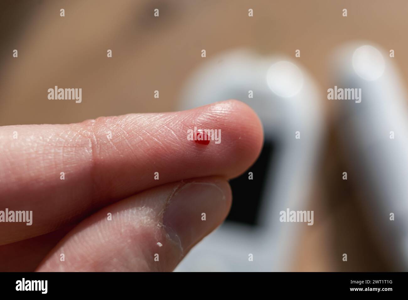 Woman pricking her finger to check blood glucose level with glucometer ...