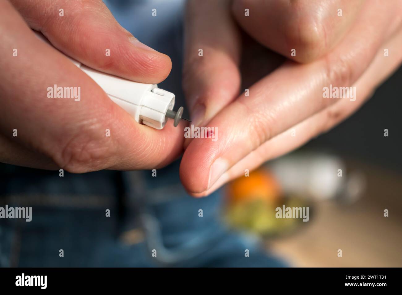 Woman pricking her finger to check blood glucose level with glucometer ...