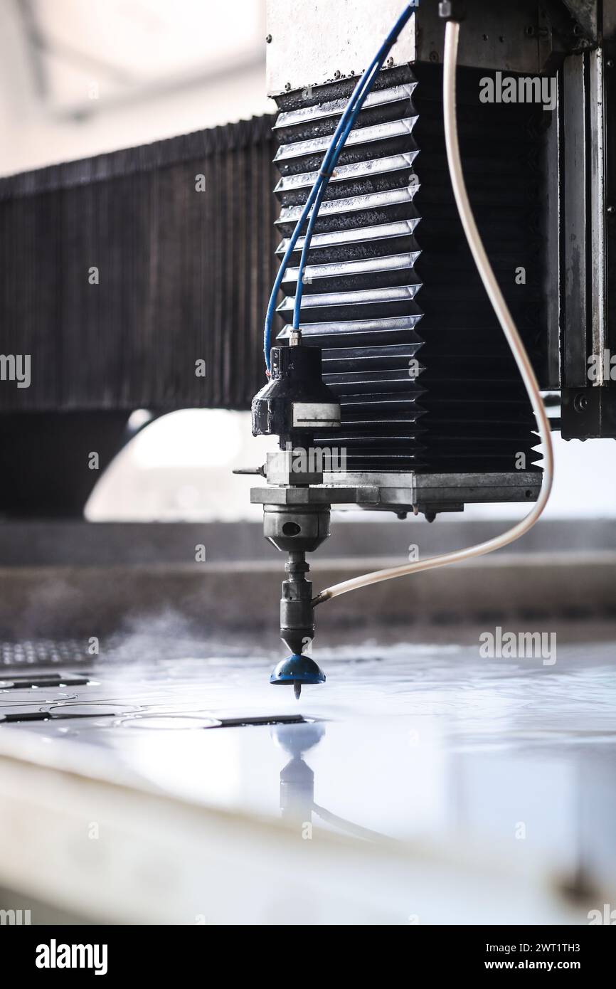High pressure water jet cutting metal plate Stock Photo - Alamy