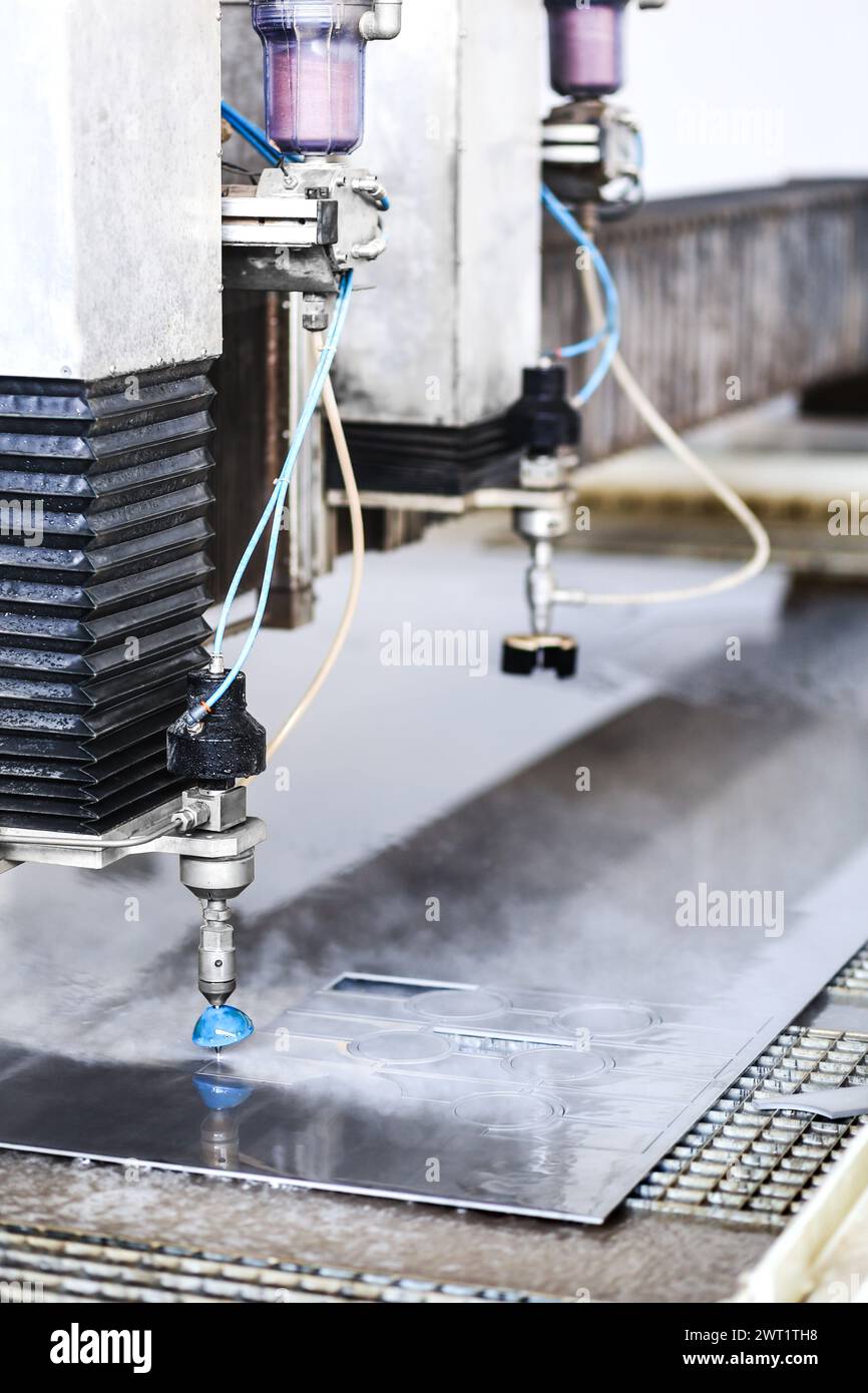 High pressure water jet cutting metal plate Stock Photo - Alamy