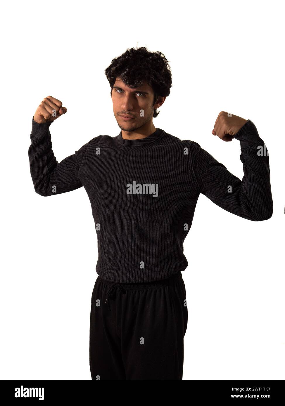 A man wearing a black sweater and pants is shown flexing his muscles in ...