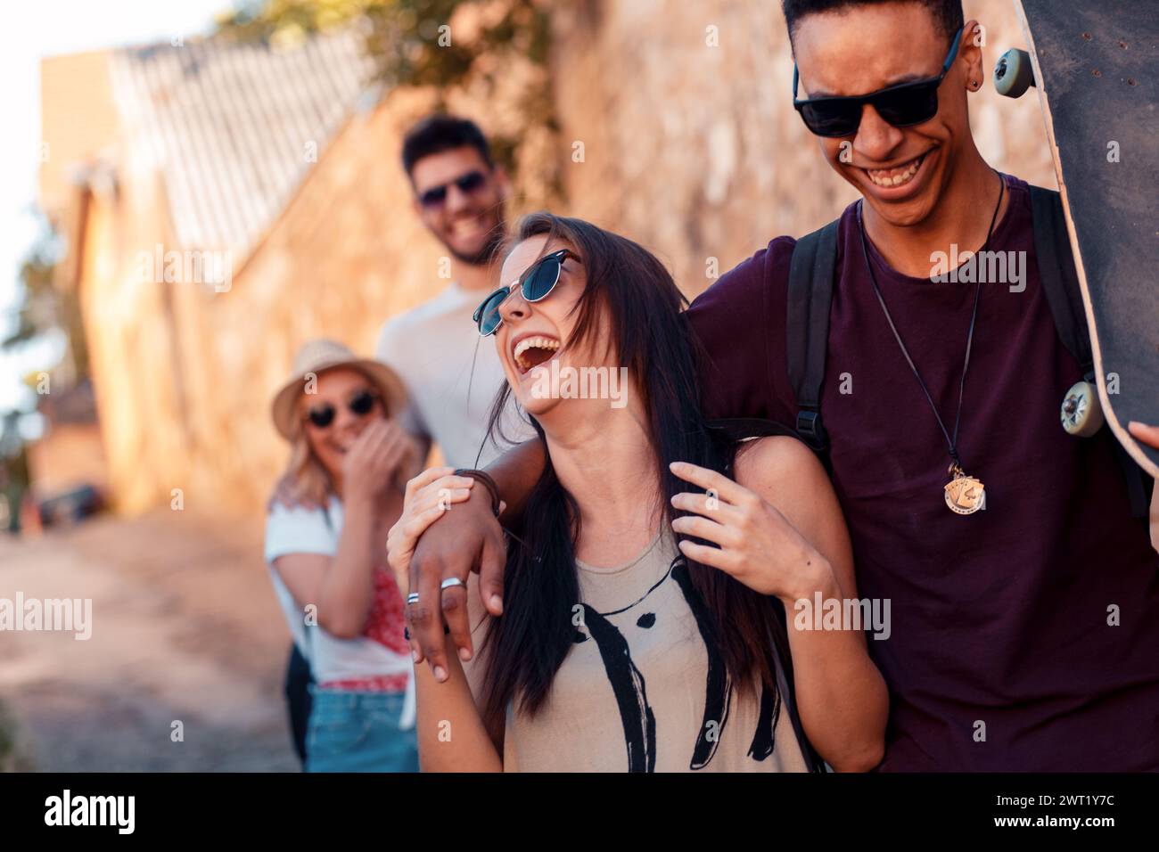 Group of friends walking having fun and laughing at the city street ...