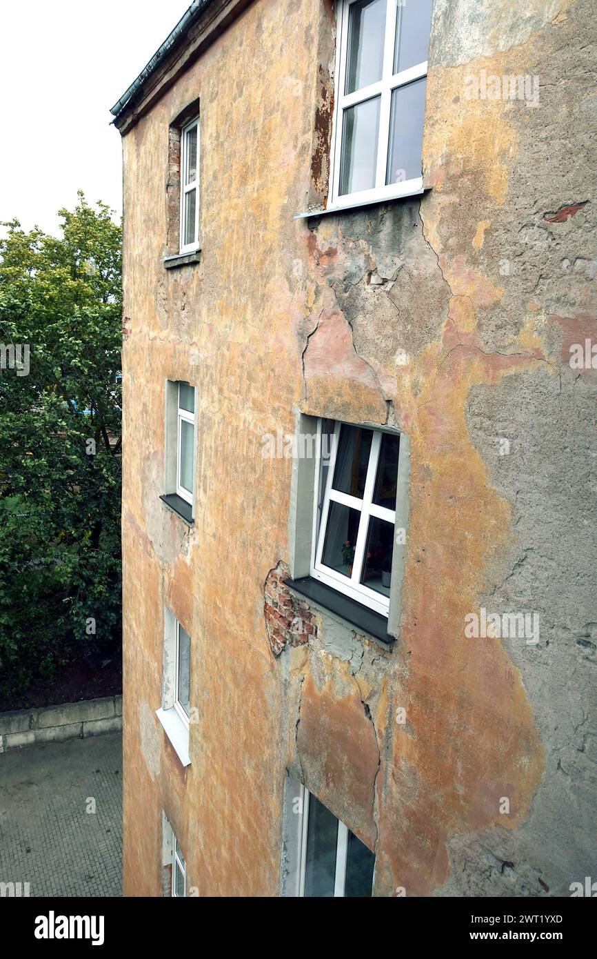 Angle of building wall in bad condition with some new plastic windows ...