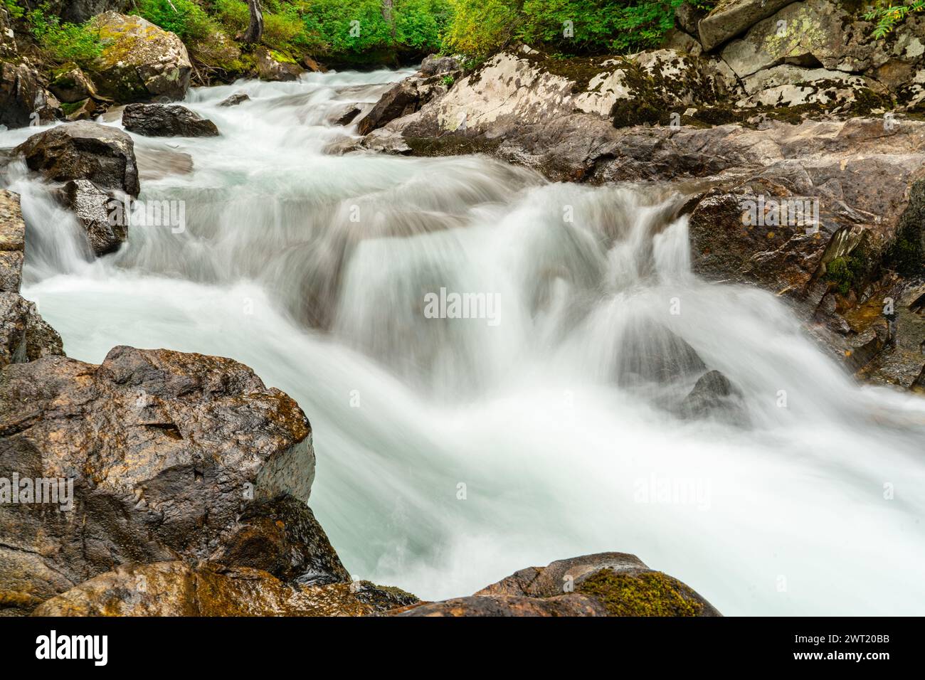 A scenic wilderness waterfall with rocks and trees Stock Photo - Alamy