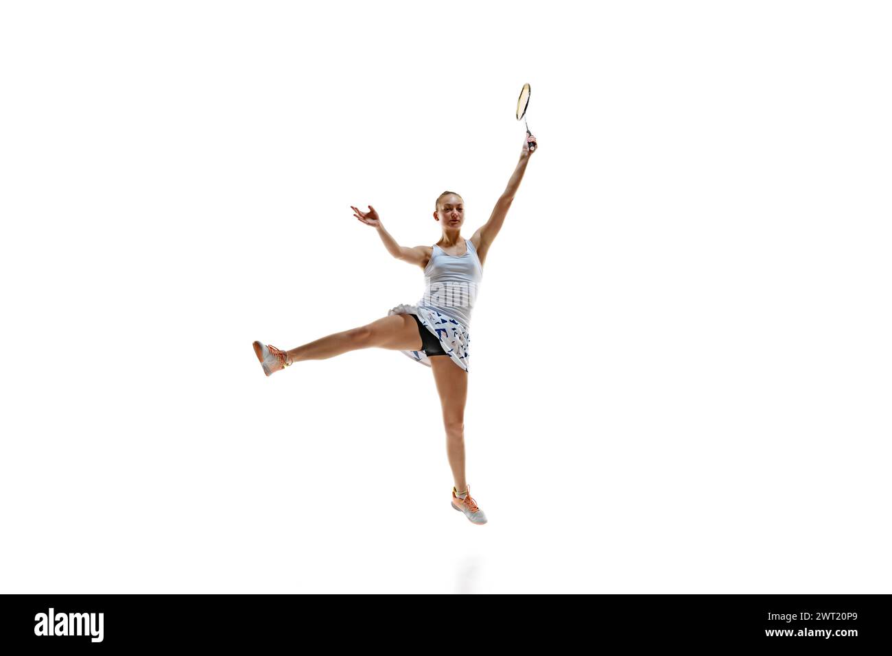 Full-length dynamic image of young girl, badminton player in motion ...