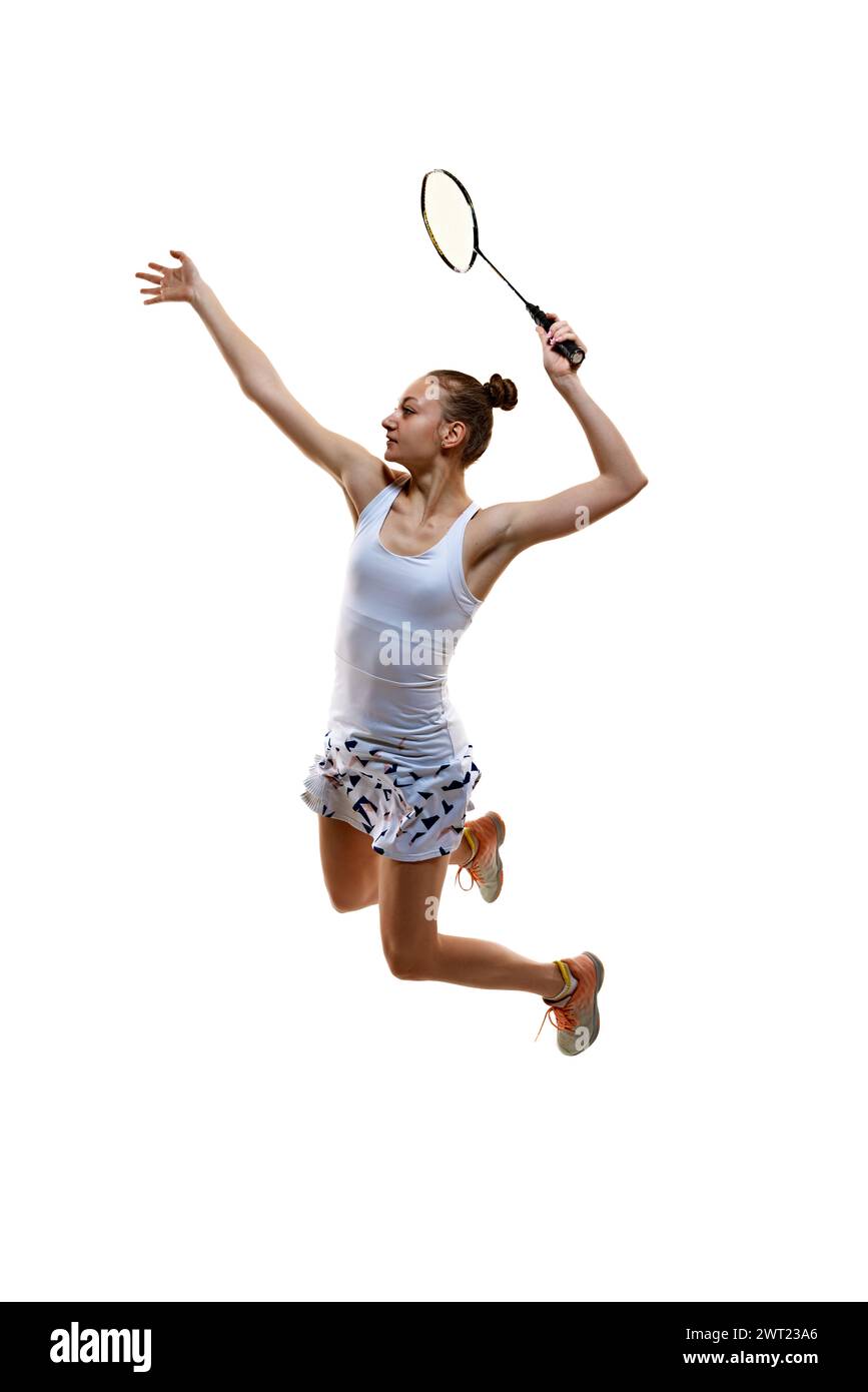 Full-length image of motivated athlete in motion, young girl, badminton ...
