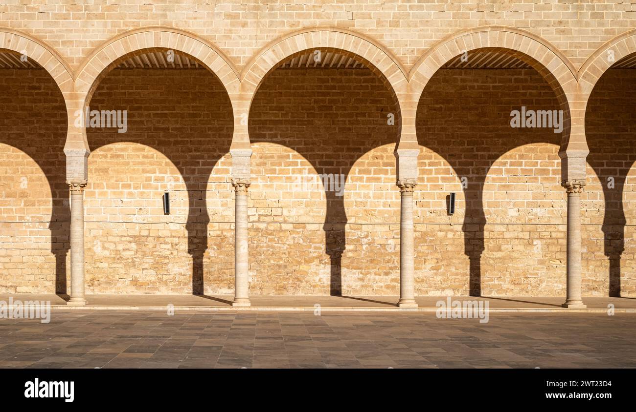 Traditional Islamic horseshoe arches along the side of the sahn, or ...