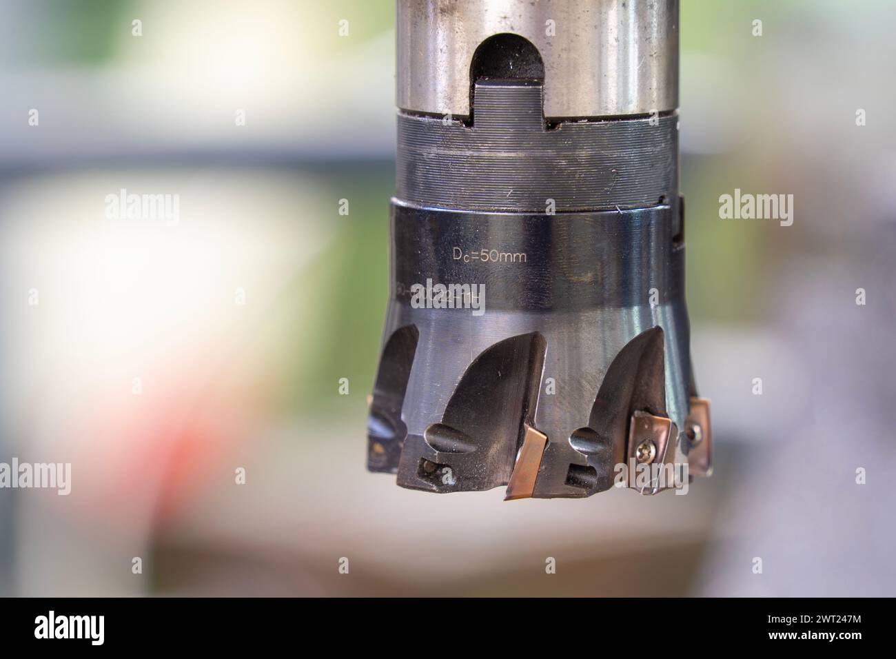 Metal milling head standing with a blurred background in a workshop ...