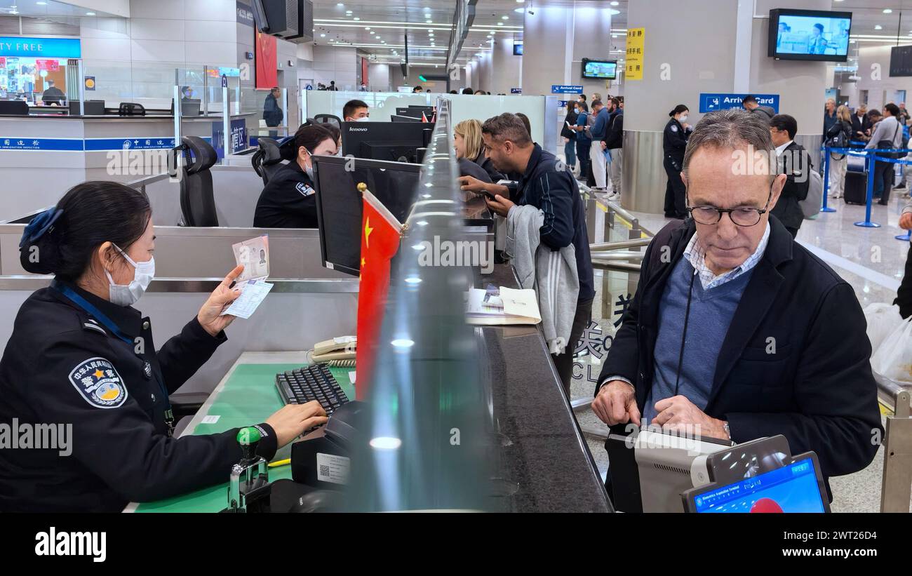 Shanghai. 14th Mar, 2024. Border police officers check documents of ...