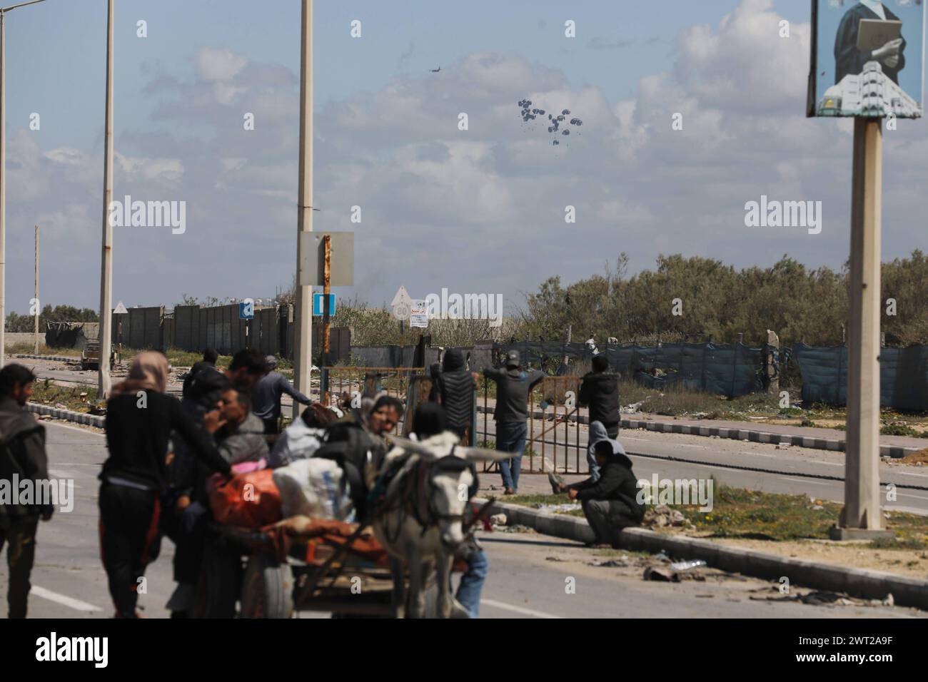 Parachutes attached to parcels of humanitarian aid are airdropped over ...