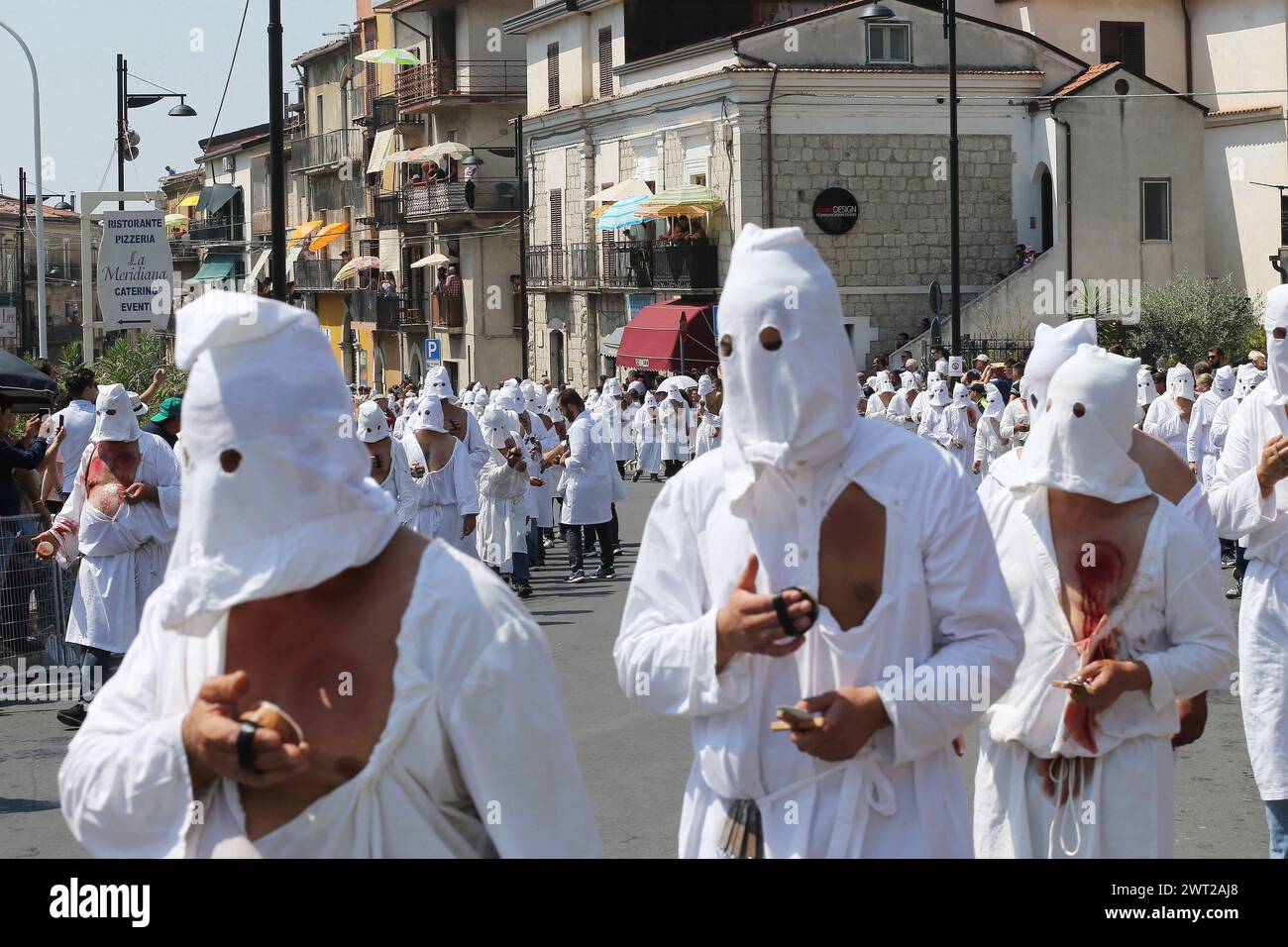 Hooded men, called "battenti", beat their chest with a sponge with a ...