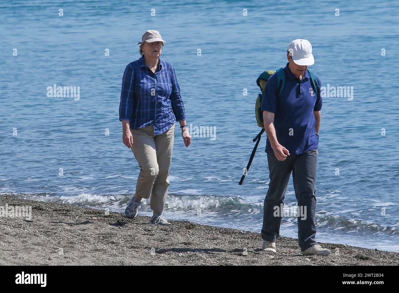 German Chancellor Angela Merkel, with her husband, take a walk to the ...